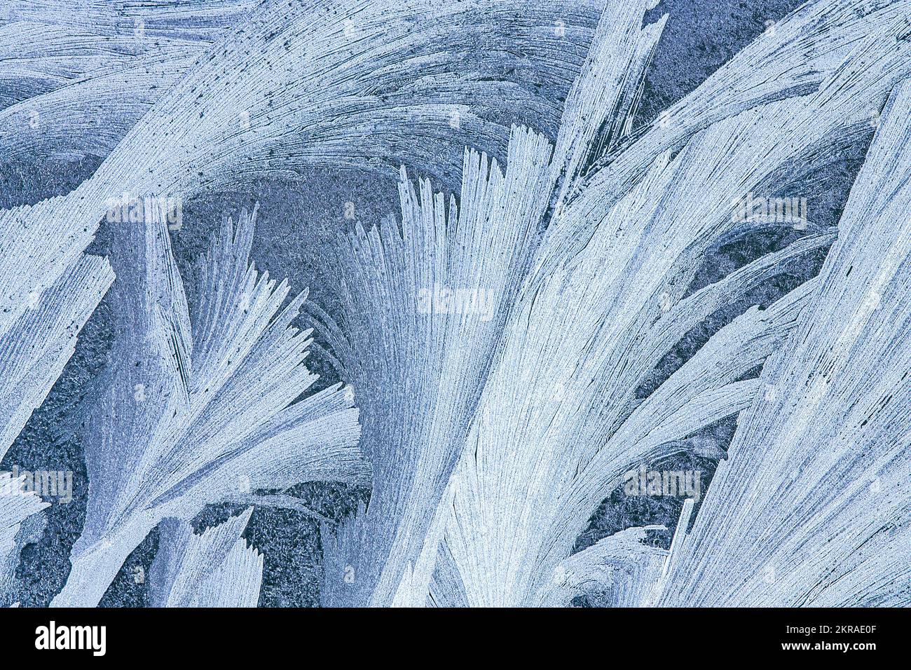frost patterns on the window glass in cold winter day. natural icy ...