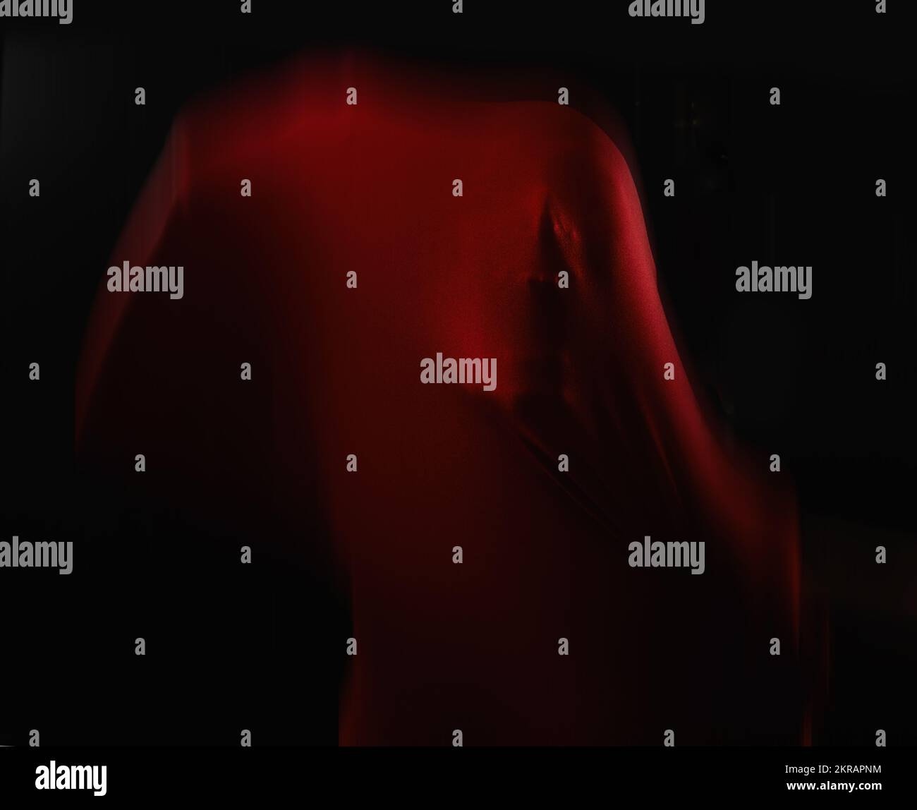 Fear personified. A human figure trapped in red fabric and struggling ...