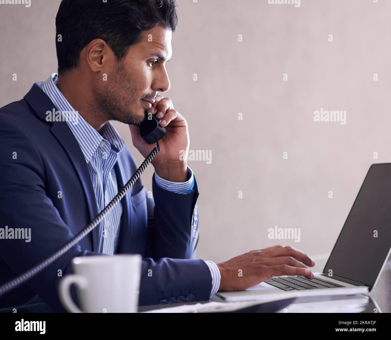 Hes working hard to complete his tasks. a handsome young businessman ...