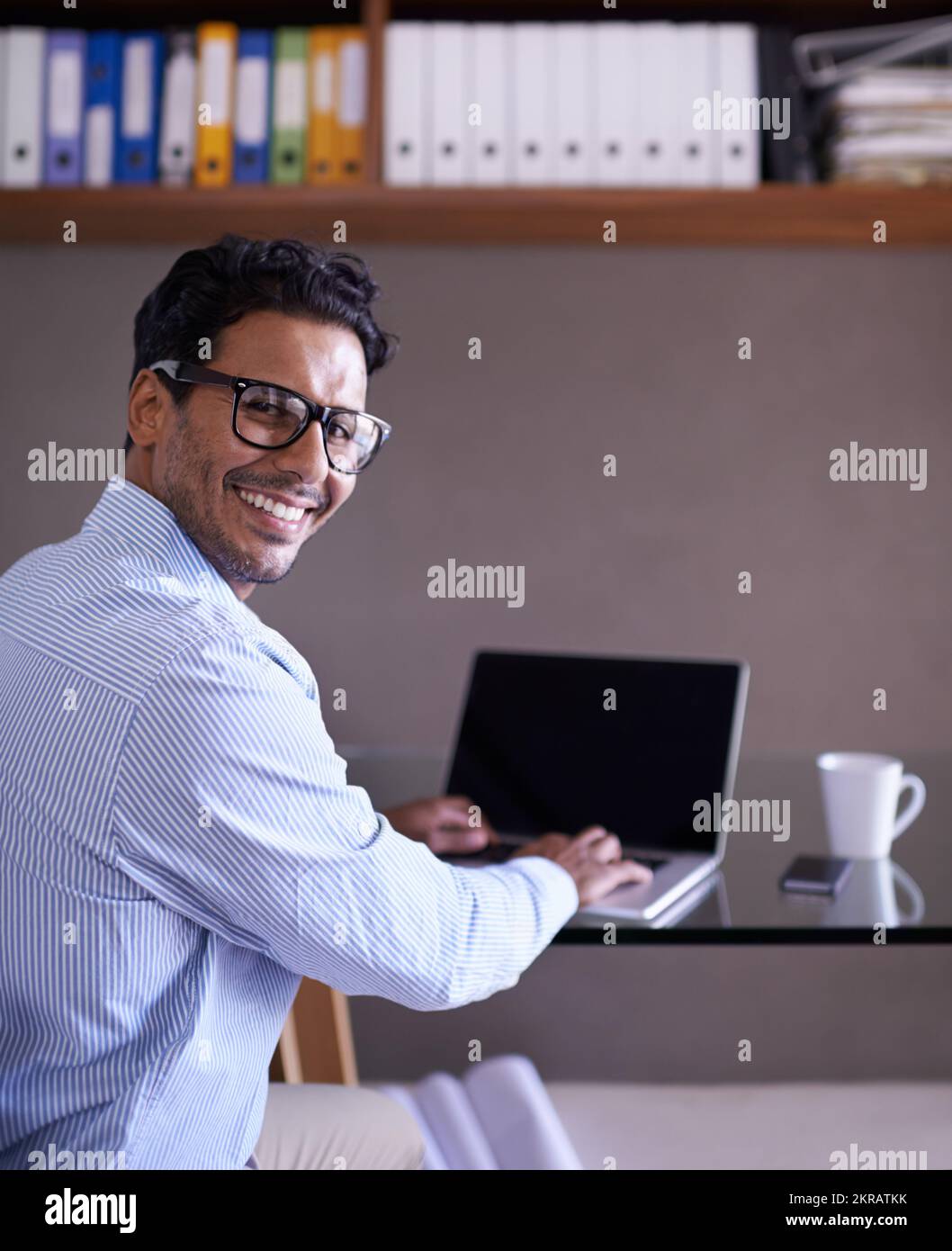 Hes working hard to complete his tasks. a handsome young businessman ...