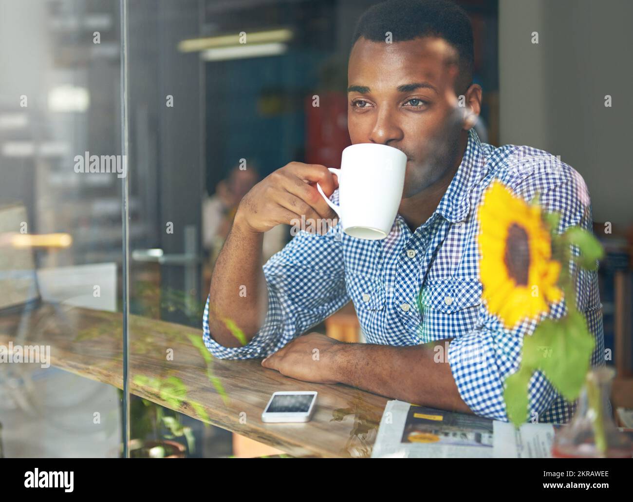 Coffee contemplations...a young man having coffee at a cafe Stock Photo ...
