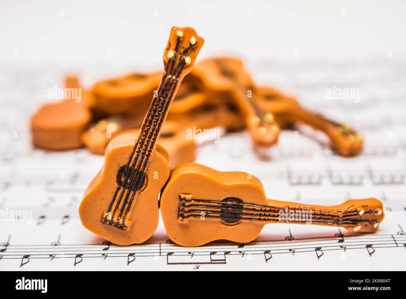 Rusty stringed wooden guitars scattered on classical rhythm musical ...