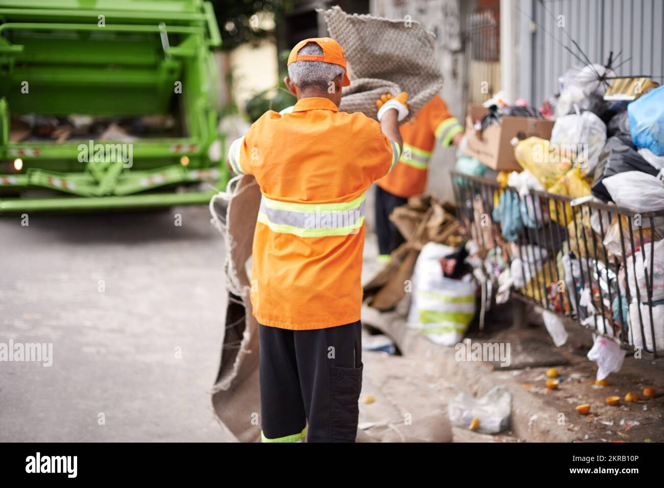 Garbage collection day. a busy garbage collection worker Stock Photo ...