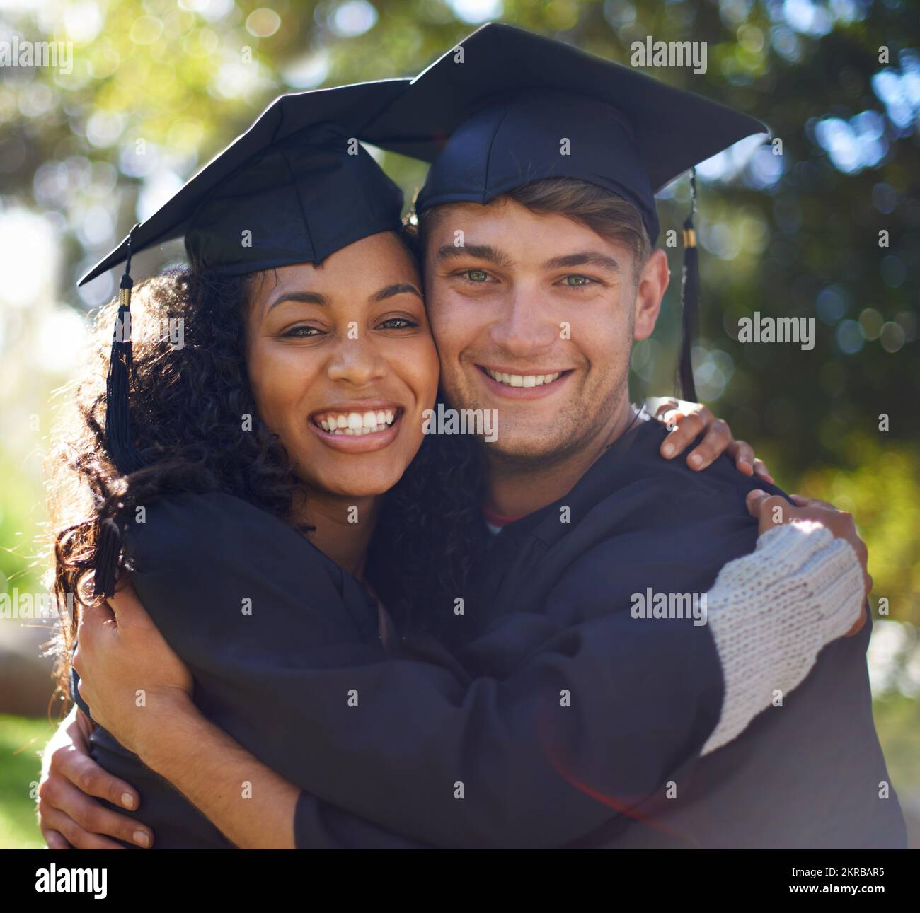 Best friends and grads. Portrait of two students embracing each other ...