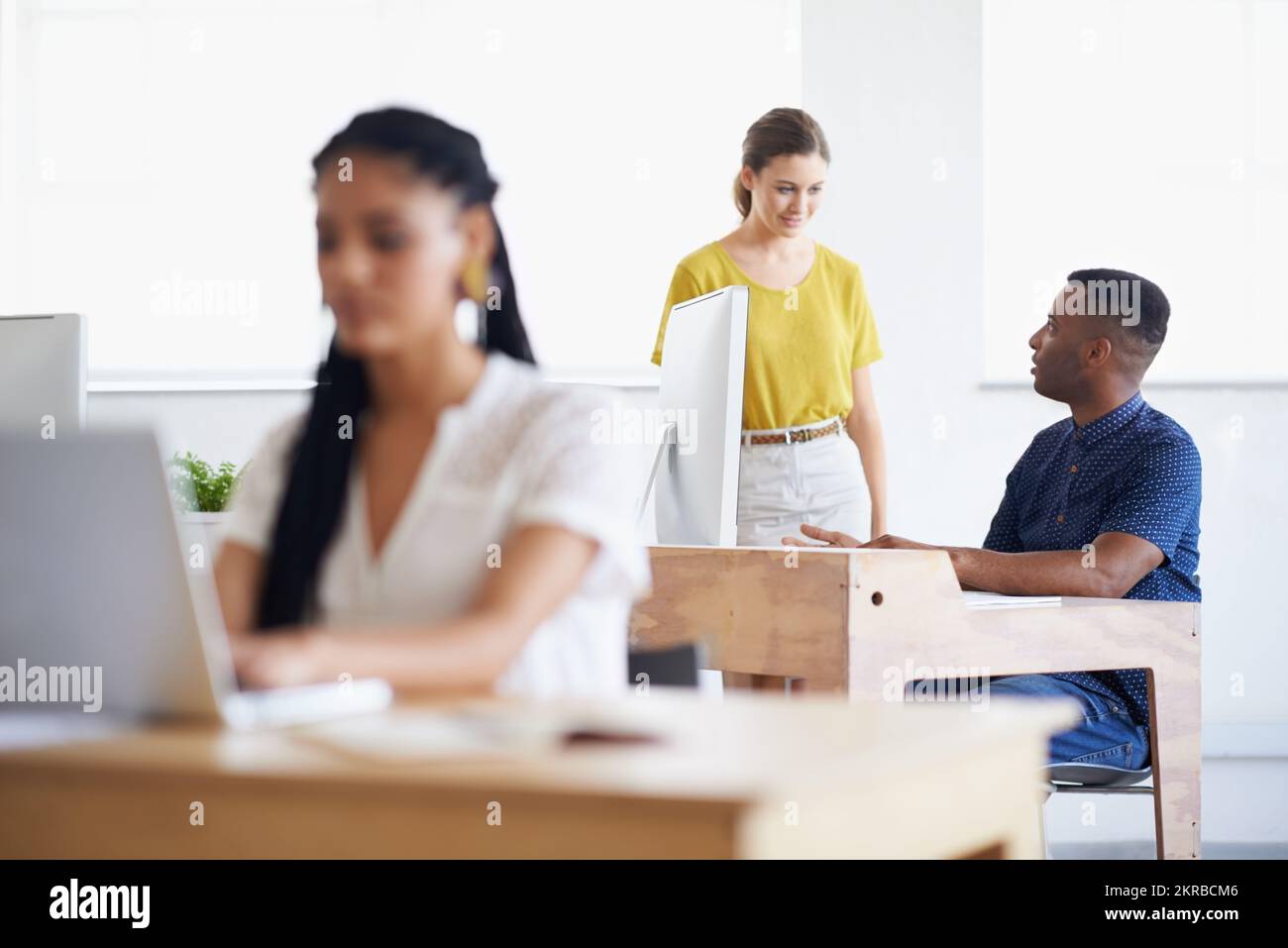 Teamwork always gets the job done. A group of colleagues working around ...