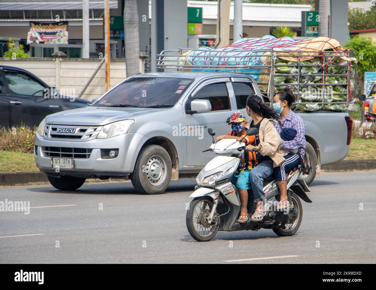 RATCHABURI, THAILAND, NOV 16 2022, women and a boy ride a motorcycle on ...