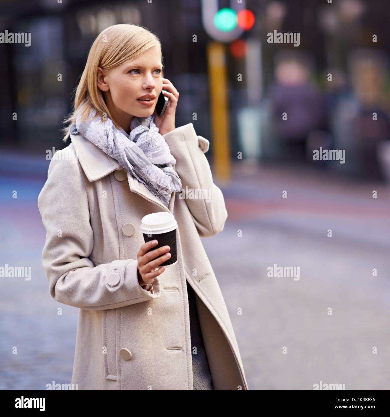 Im nearly there...a young woman talking on her cellphone while walking ...
