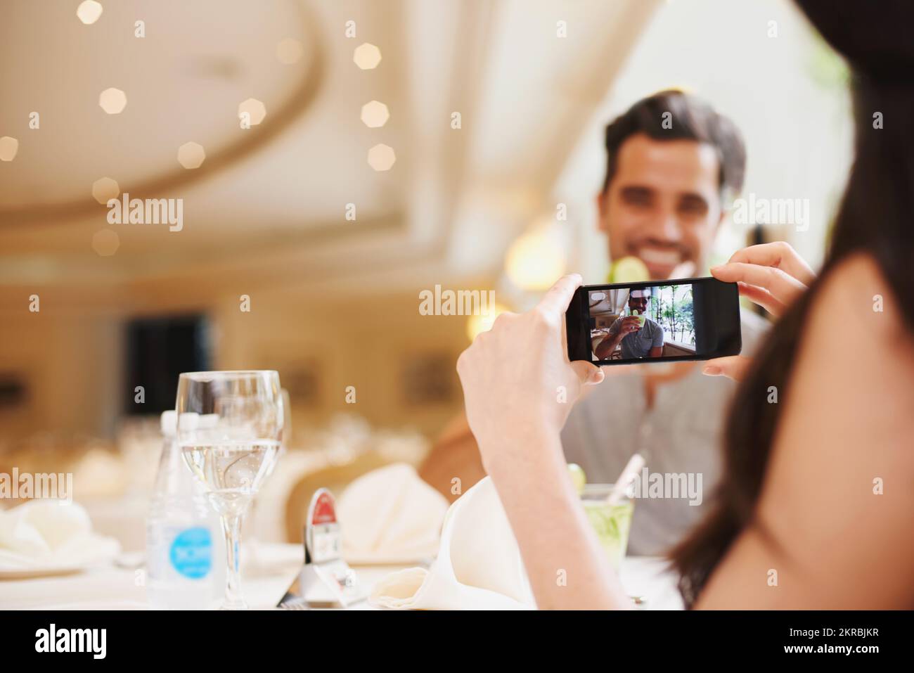 Smile for the camera, honey. A woman taking a picture of her partner ...