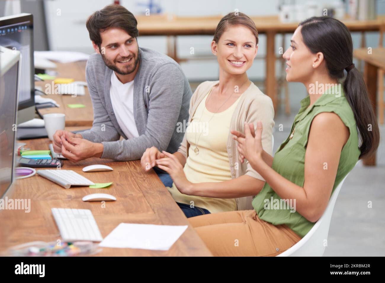 Catching up with colleagues. a group of young businesspeople talking at ...