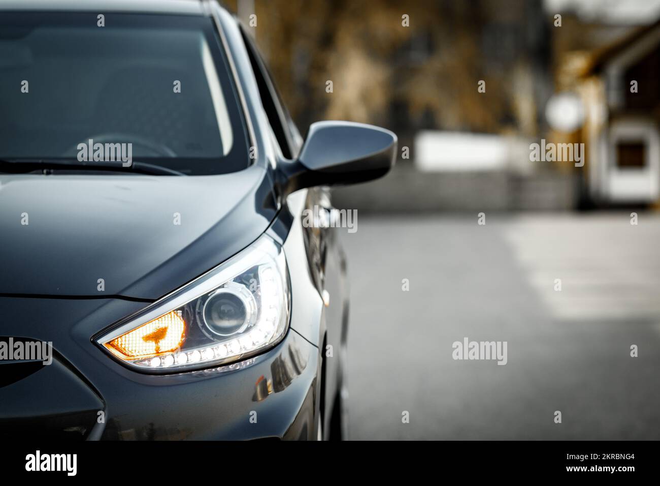 Front optics and side rear view mirror of a gray car Hyundai Accent ...