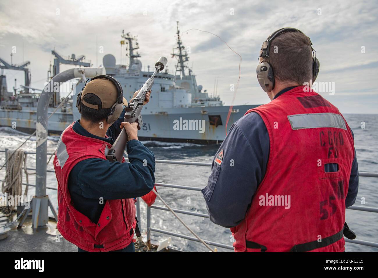 Fire Controlman 3rd Class Daniel Trujillo, left, shoots a shot line to ...