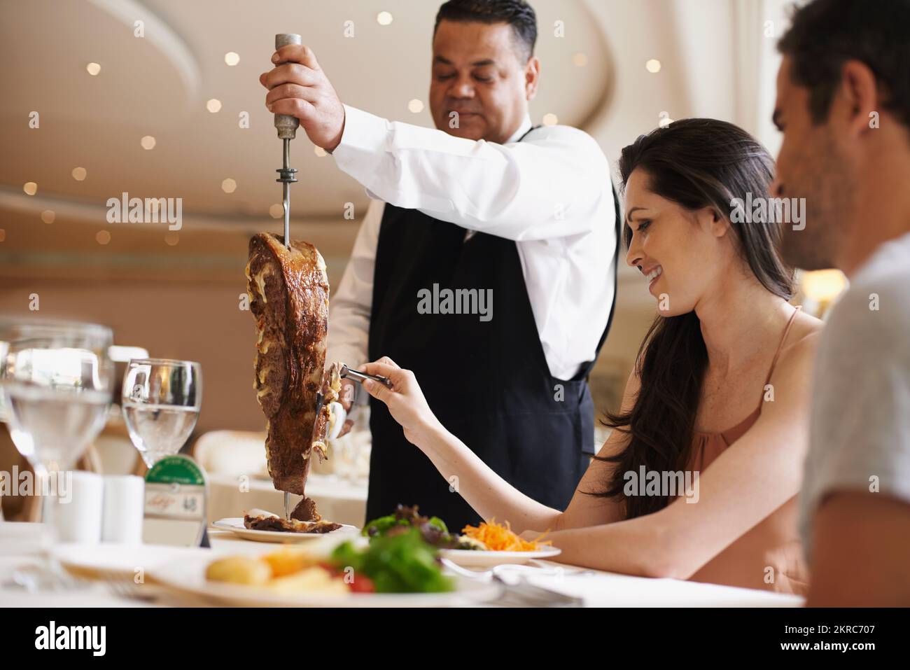 Enjoying the restaurants speciality. A happy couple enjoying a meal at ...