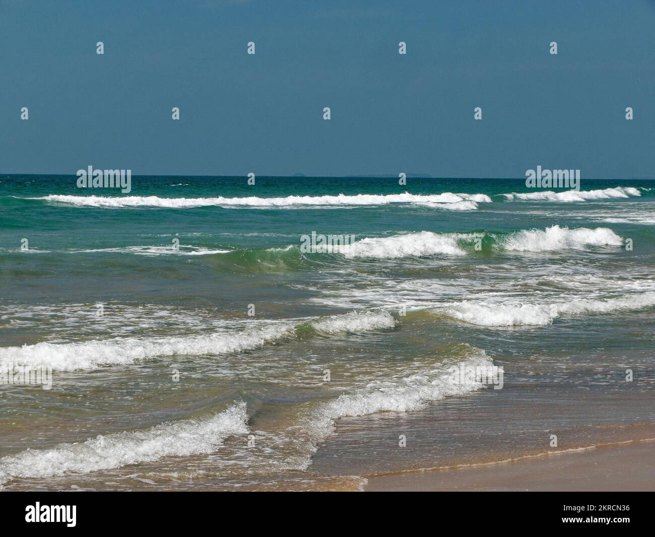 View of a tropical wave water seashore and sandy beach of Mobor in ...