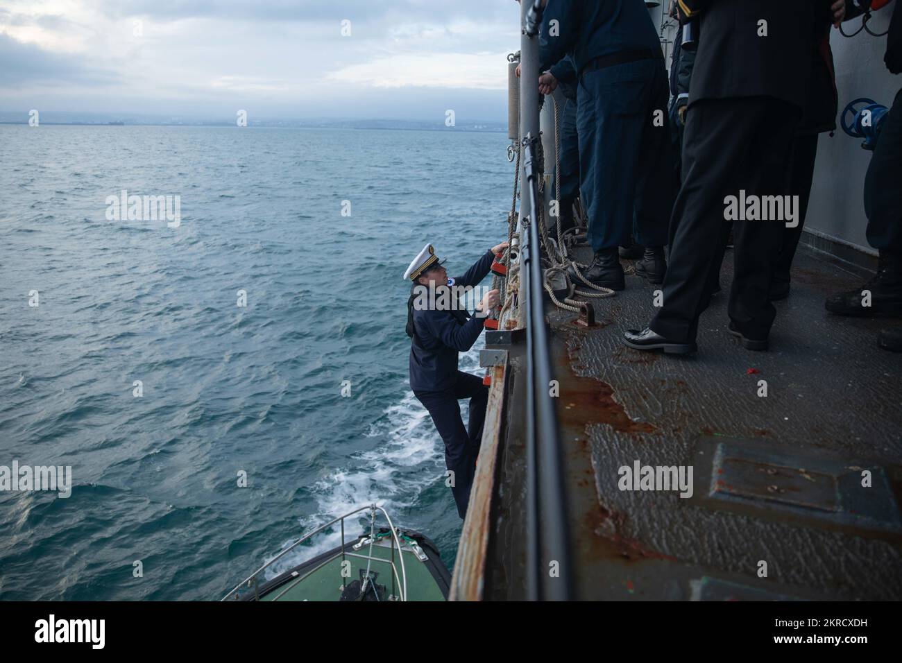 A French pilot boat captain climbs aboard the Ticonderoga-class guided ...