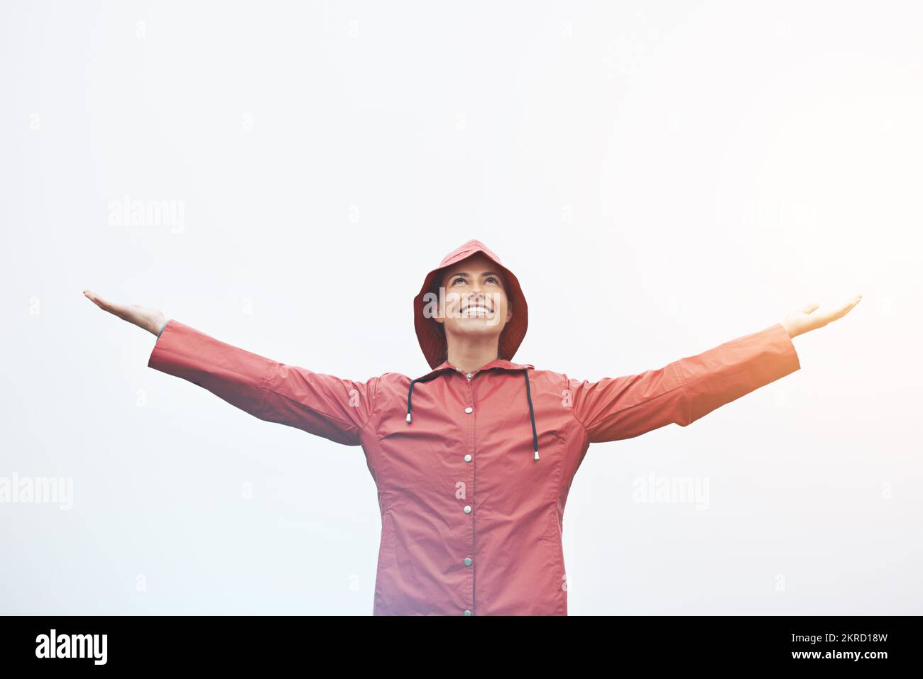 Embracing the weather. an attractive young woman standing with her arms ...