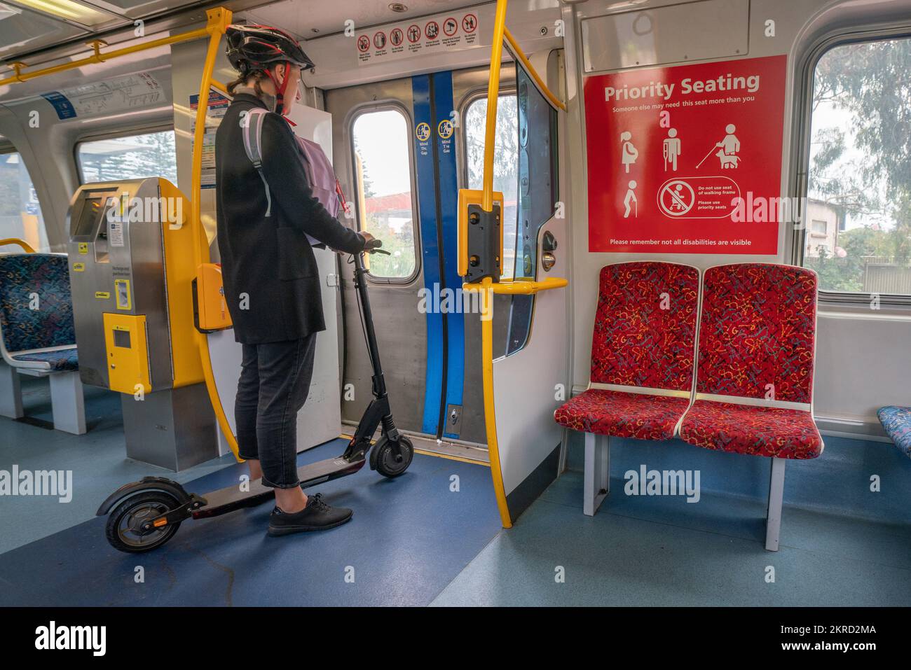 Electric scooter rider on a commuter train , Adelaide, Australia Stock ...