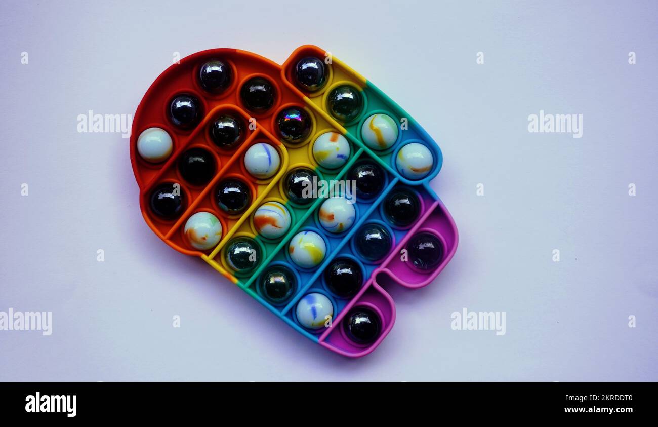 Close up colorful toy push it in white background for education Stock ...