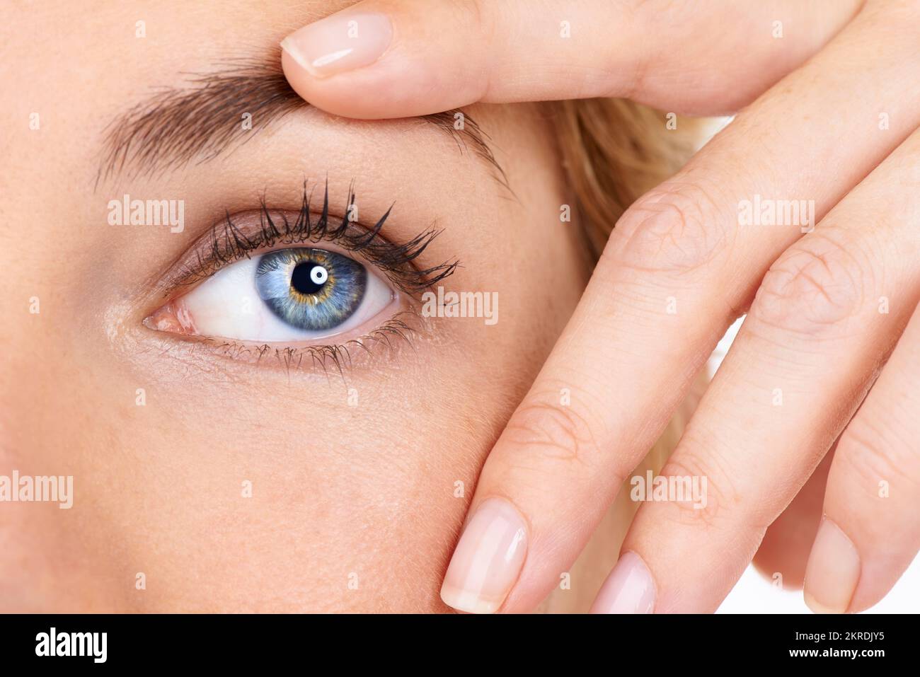 Avoid crows feet by keeping your eyes moisturized. A closeup of a young ...