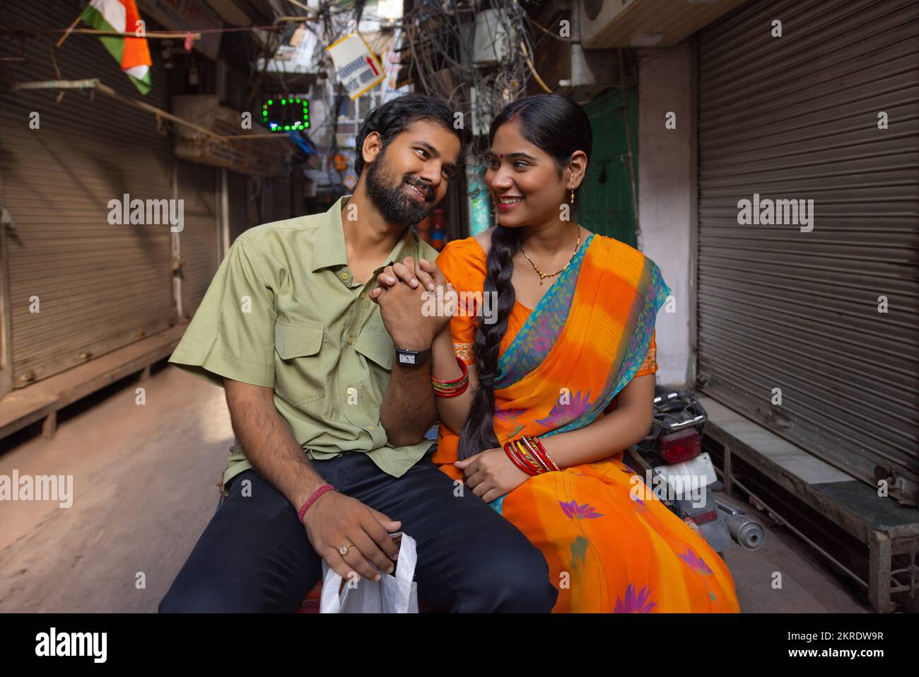Romantic couple riding a rickshaw with holding their hands together ...