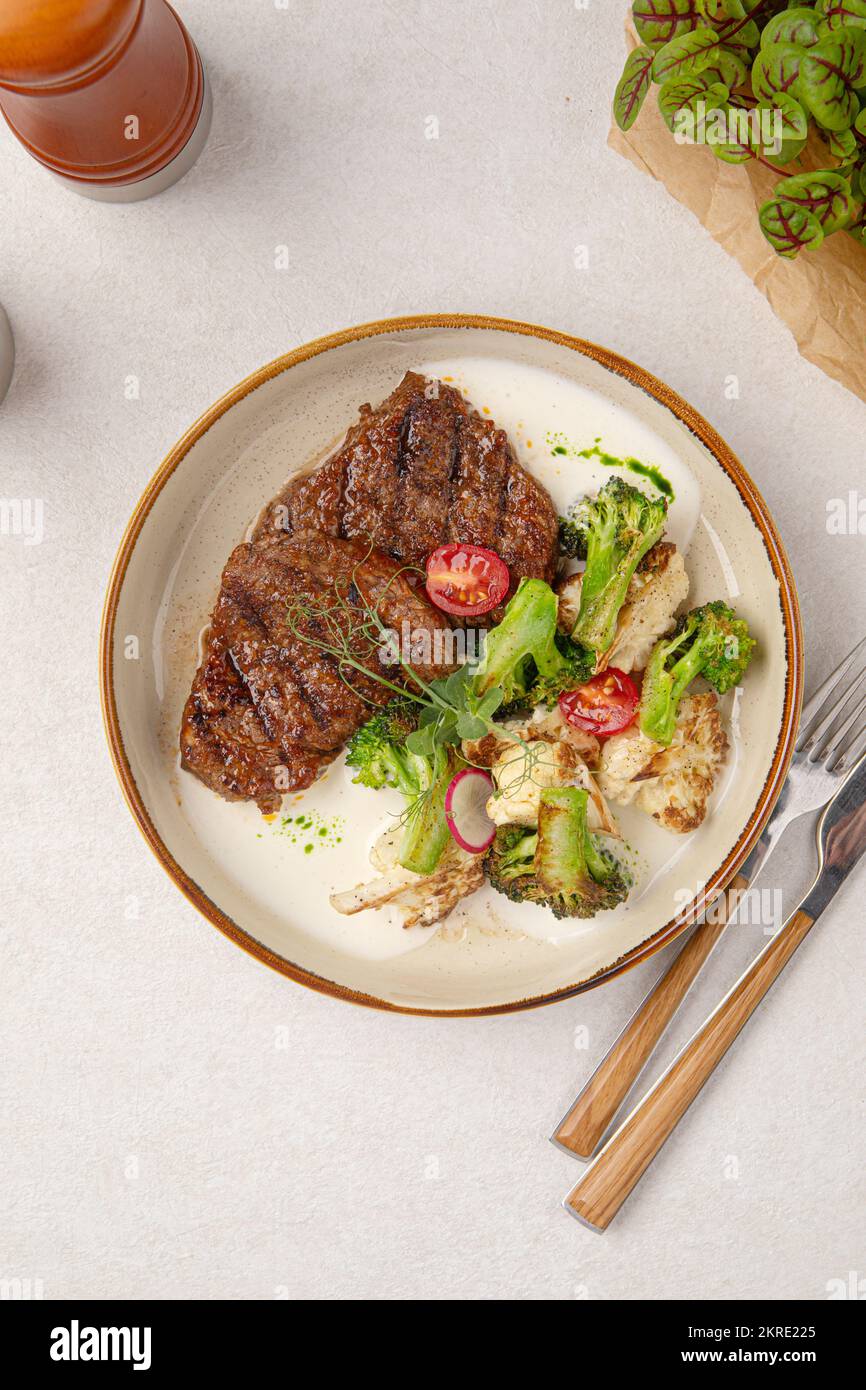 Portion of beef steak with vegetable salad Stock Photo - Alamy
