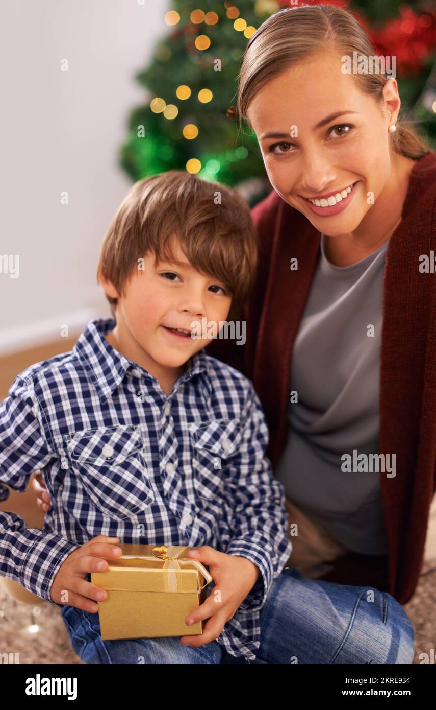 Mom always gets me the best gifts. a young boy opening a Christmas ...