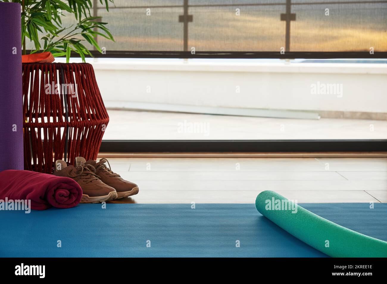 Empty fitness place with mat, towel and sneakers ready for workout ...