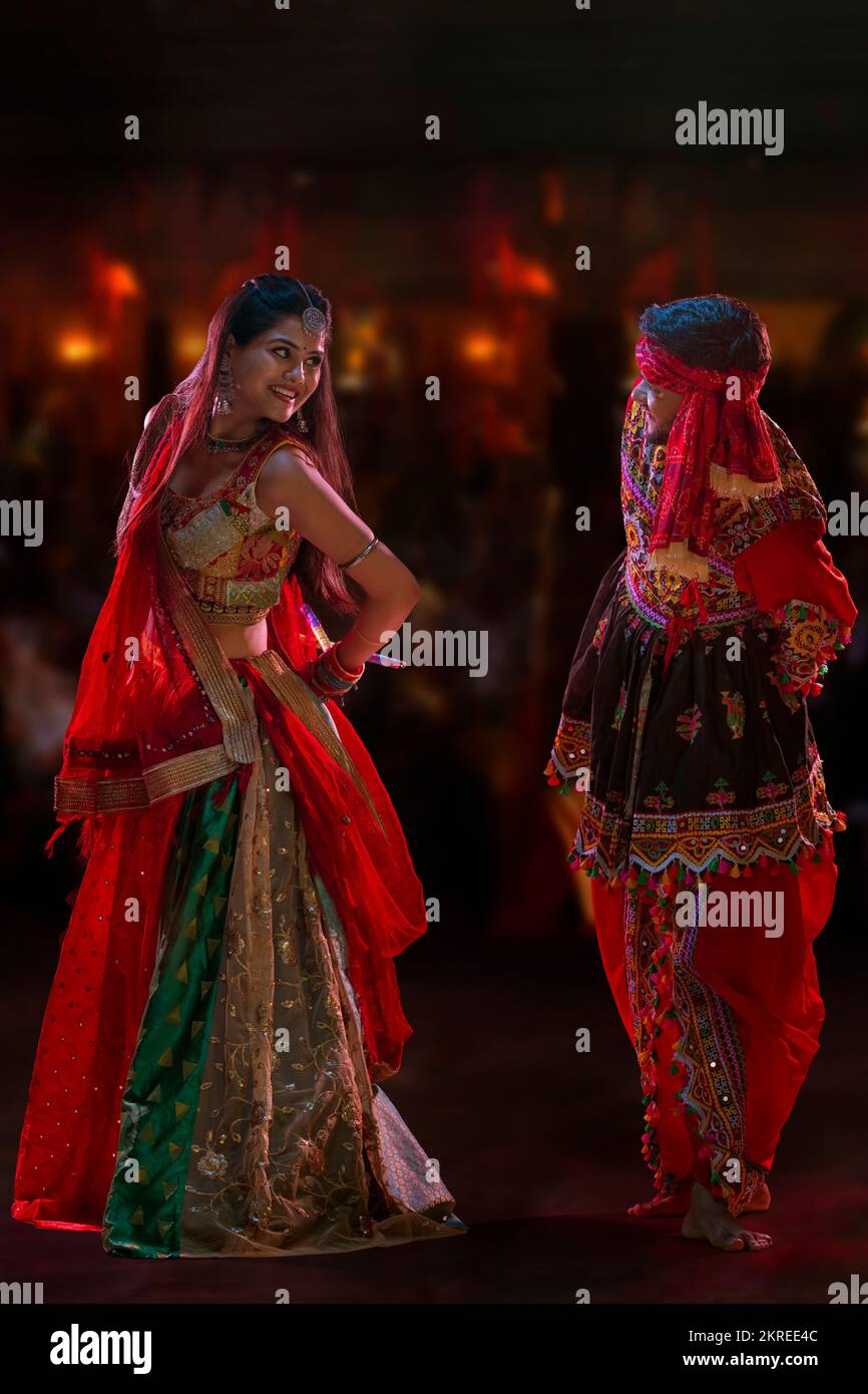 Gujrati couple performing Garba on stage Stock Photo - Alamy