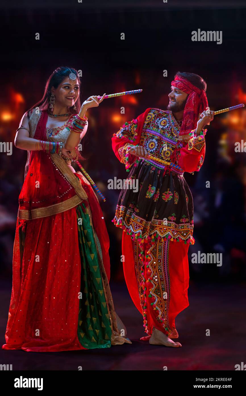 Gujrati couple performing Garba on stage Stock Photo - Alamy