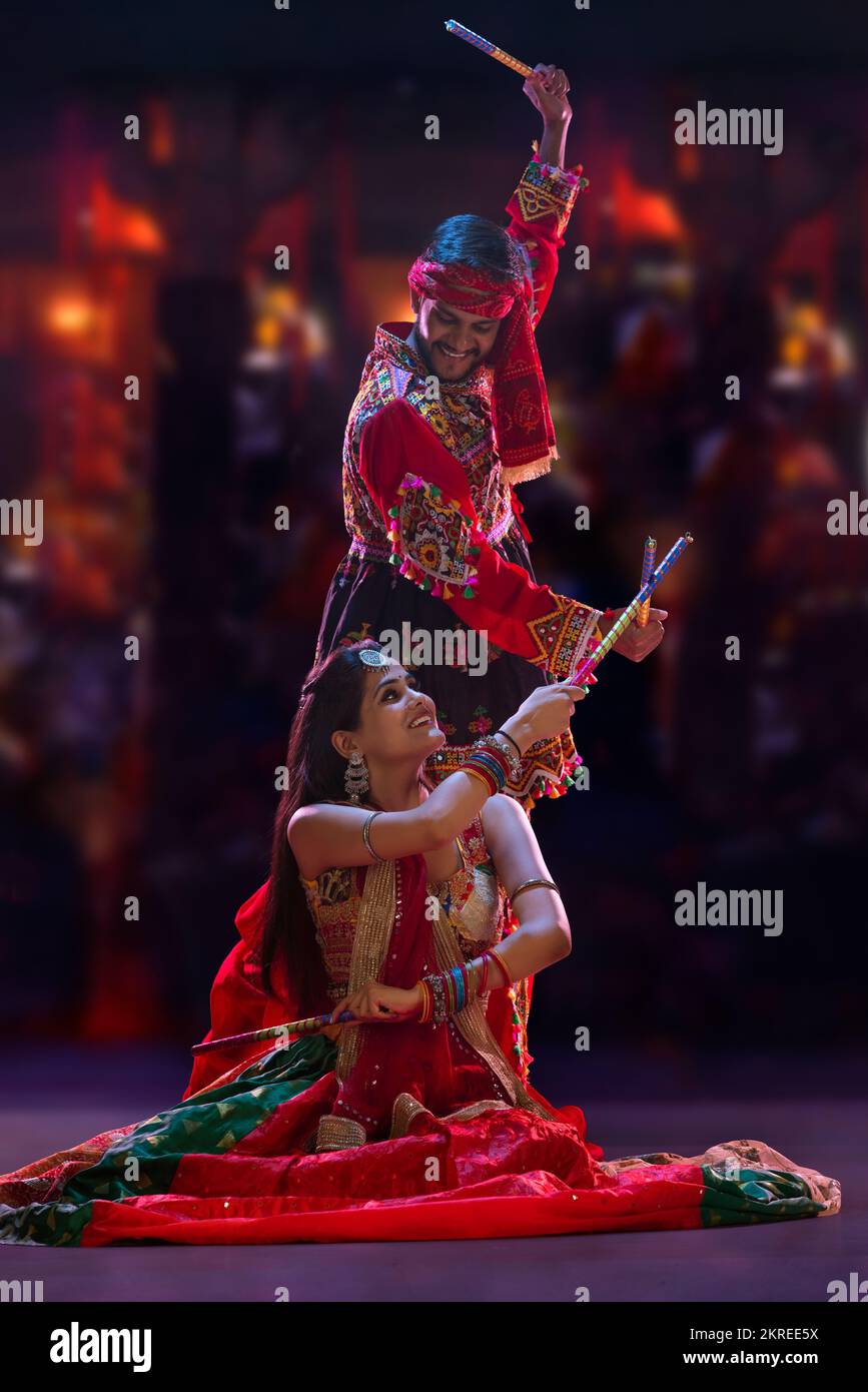 Gujrati couple performing Garba on stage Stock Photo - Alamy
