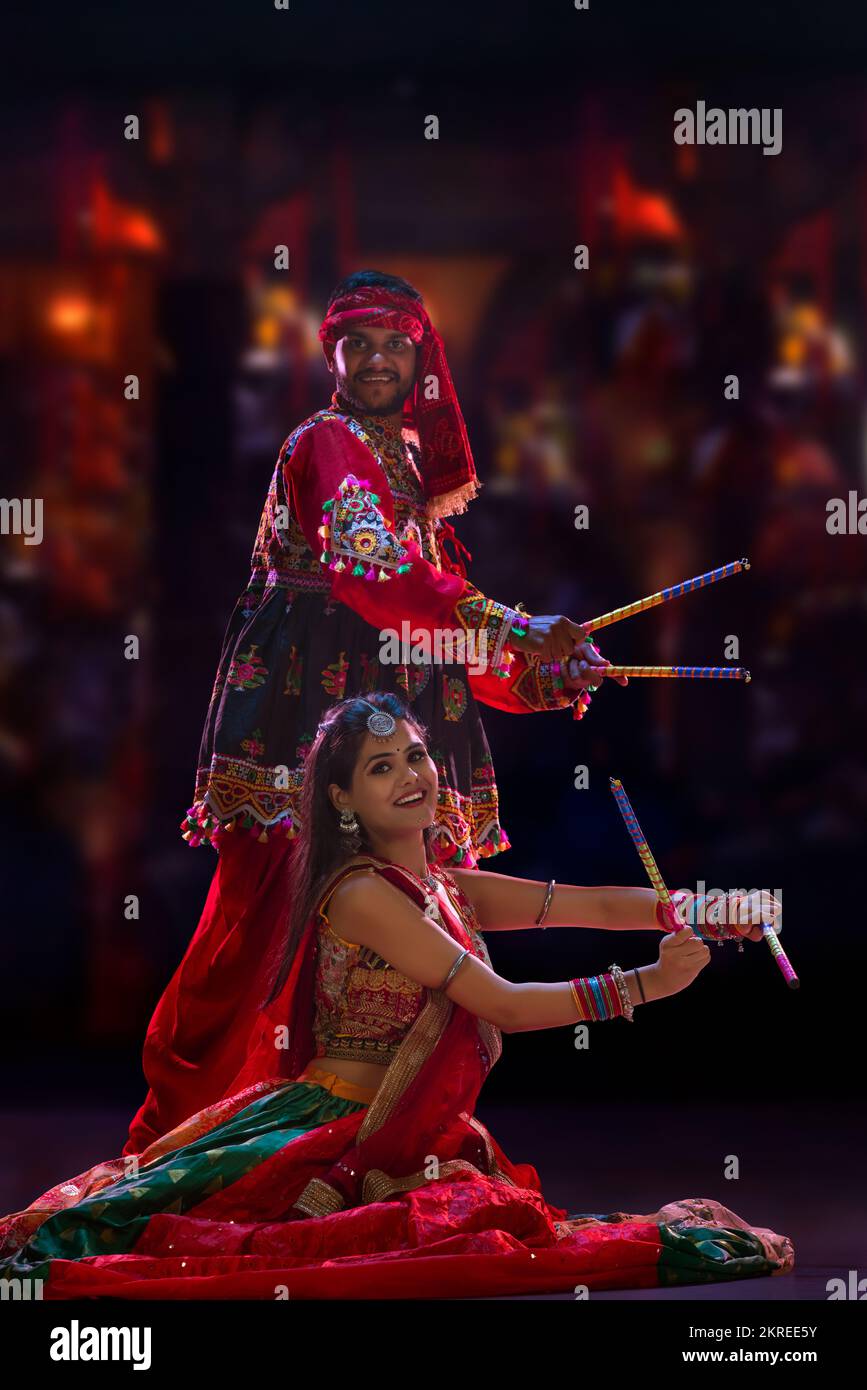 Gujrati couple performing Garba on stage Stock Photo - Alamy