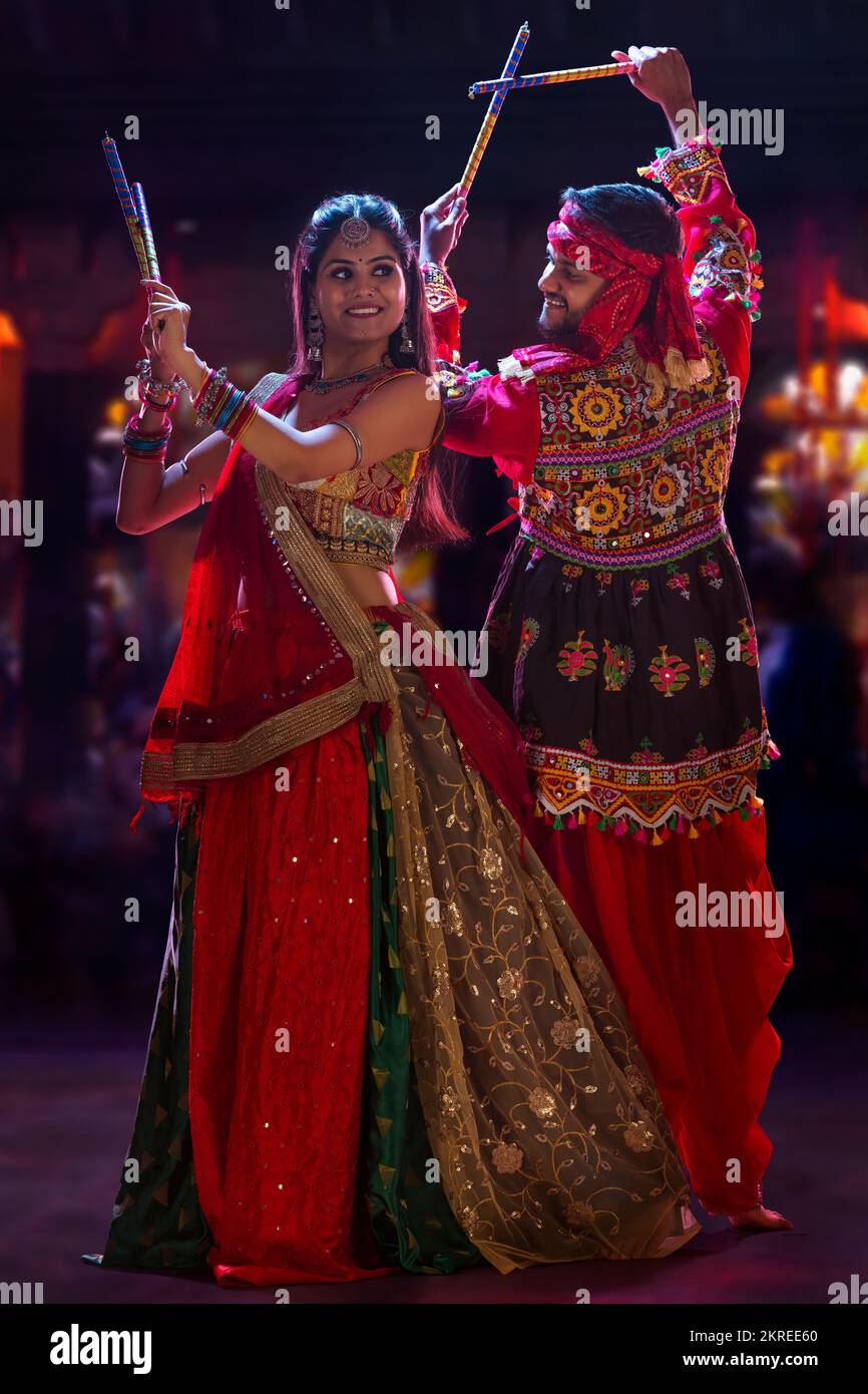 Gujrati couple performing Garba on stage Stock Photo - Alamy