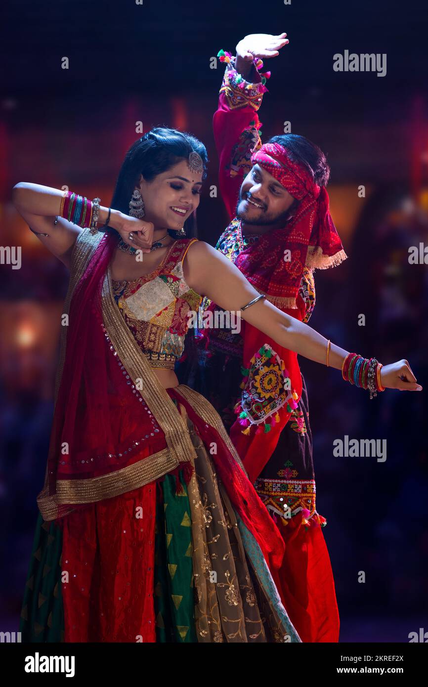 Gujrati couple performing Garba on stage Stock Photo - Alamy