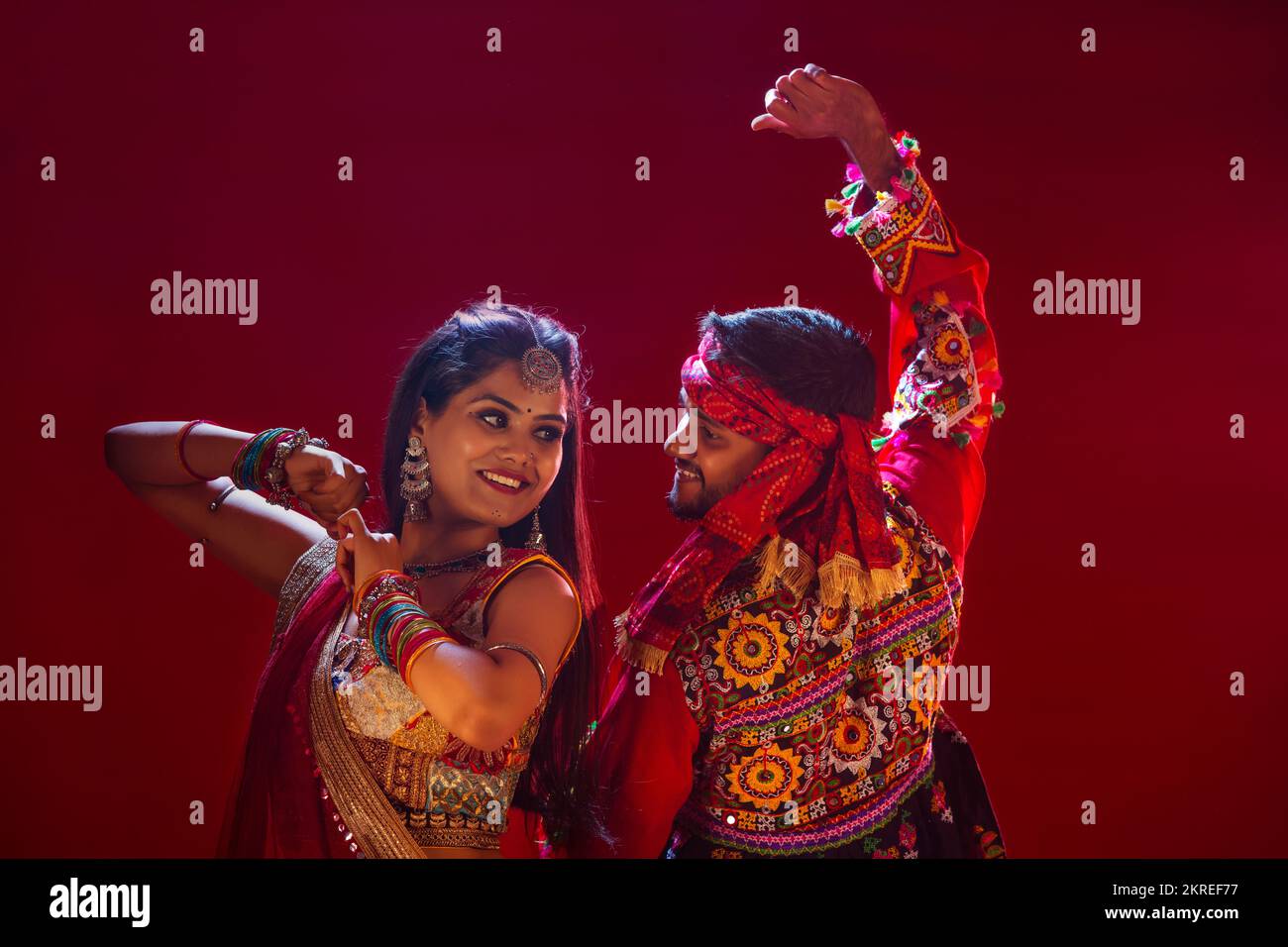 Gujrati couple performing Garba on stage Stock Photo - Alamy
