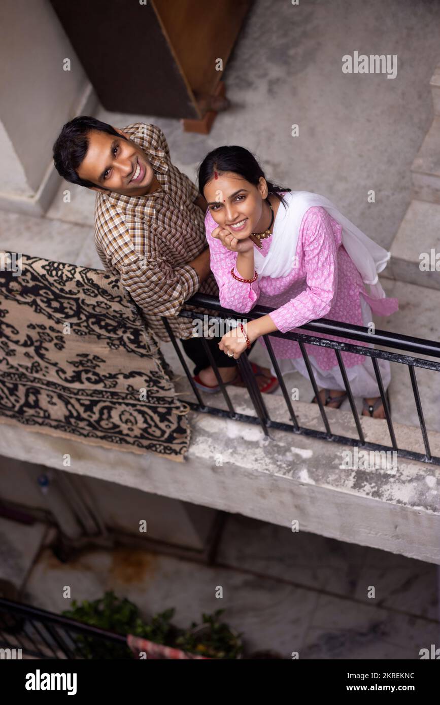 Overhead view of young couple standing in balcony Stock Photo - Alamy