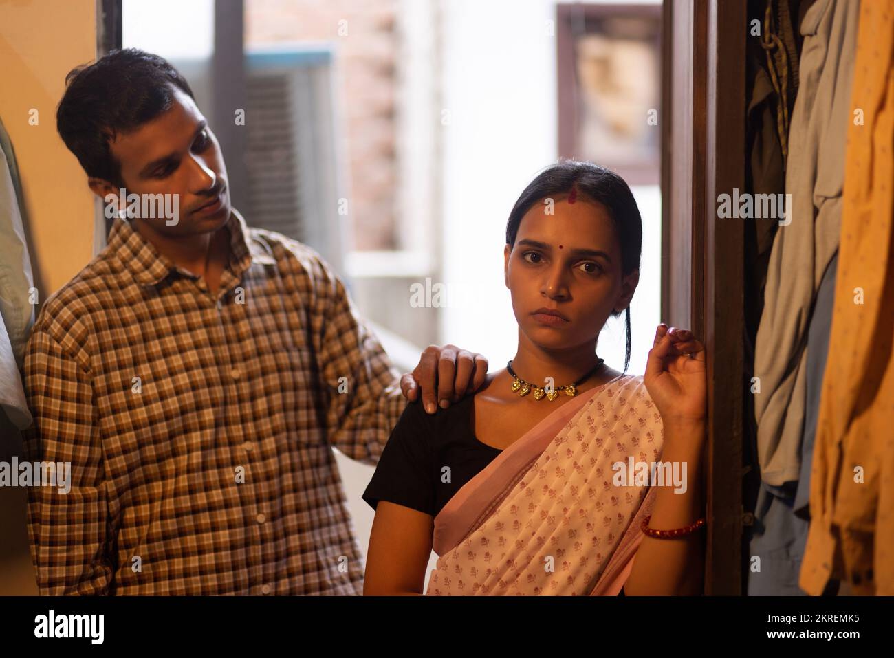 Portrait of young couple standing on the doorstep Stock Photo - Alamy