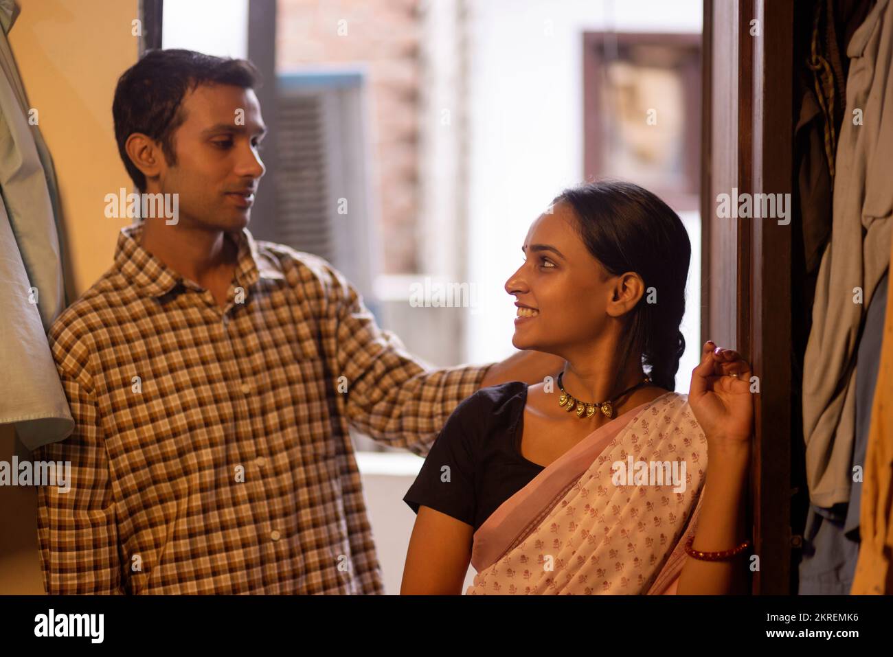Portrait of young couple standing on the doorstep Stock Photo - Alamy