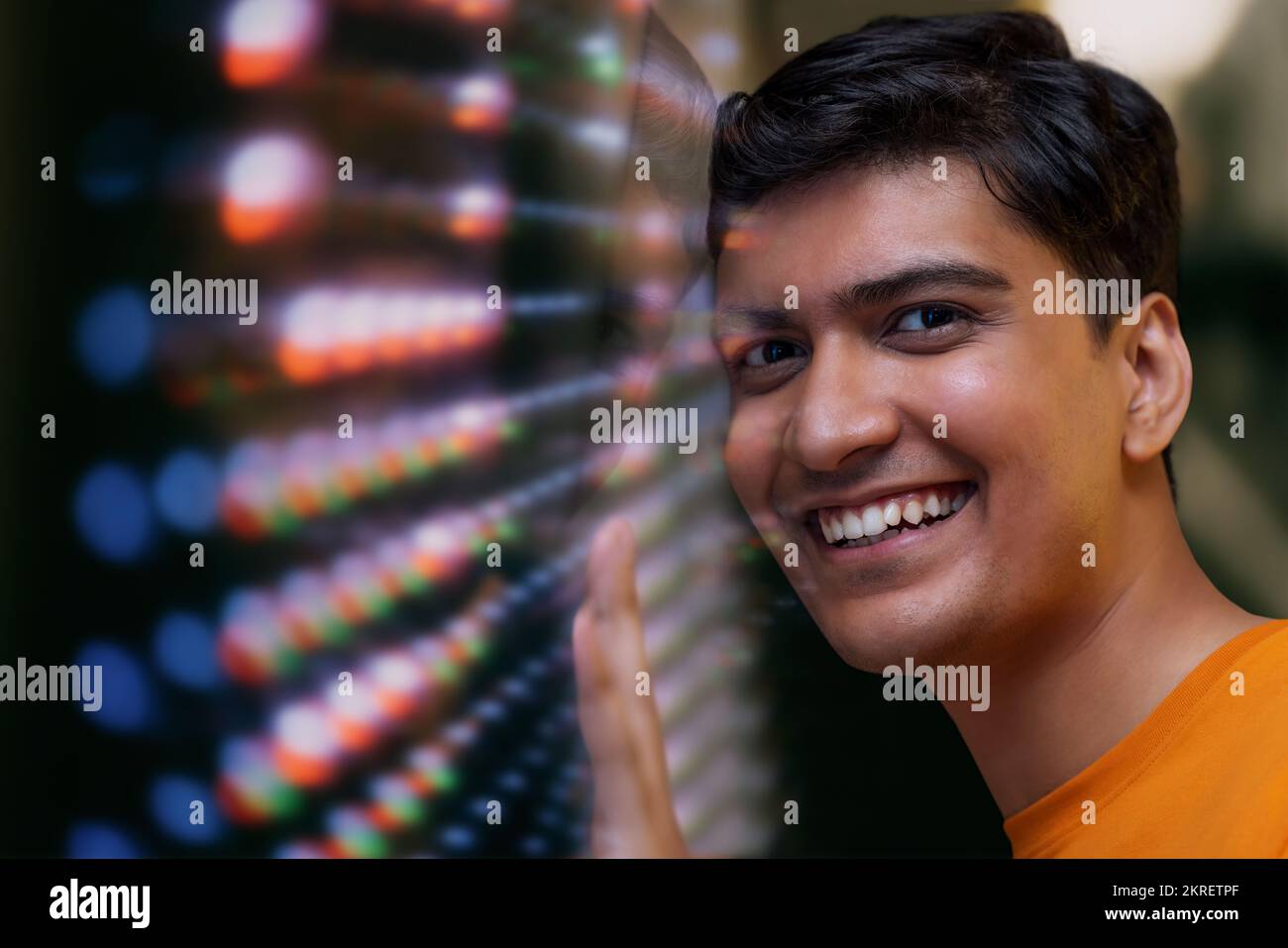 Happy young man with futuristic digital screen Stock Photo - Alamy