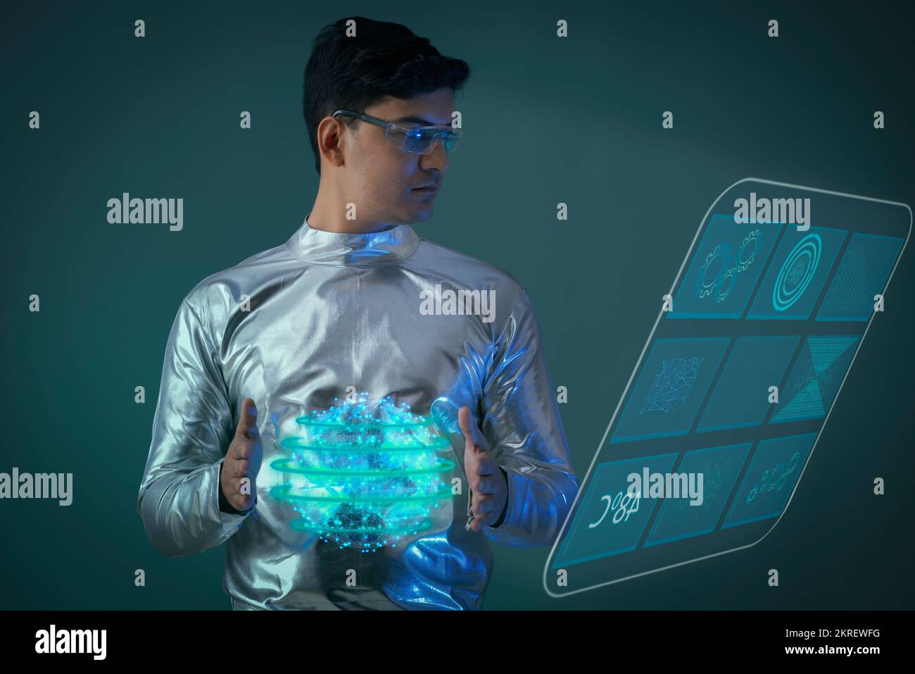A man wearing silver, futuristic clothes holding digital globe, and ...