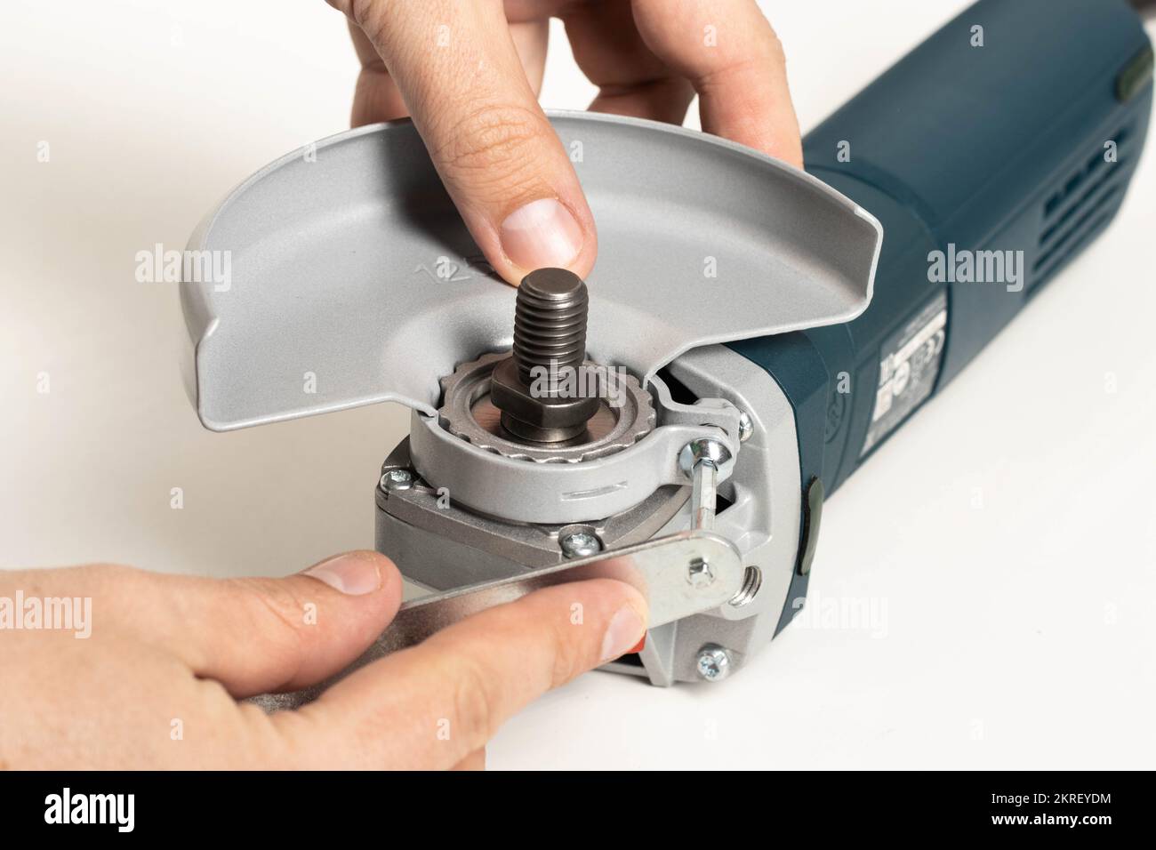 Installing the safety cover on an angle grinder, close-up. Safety ...