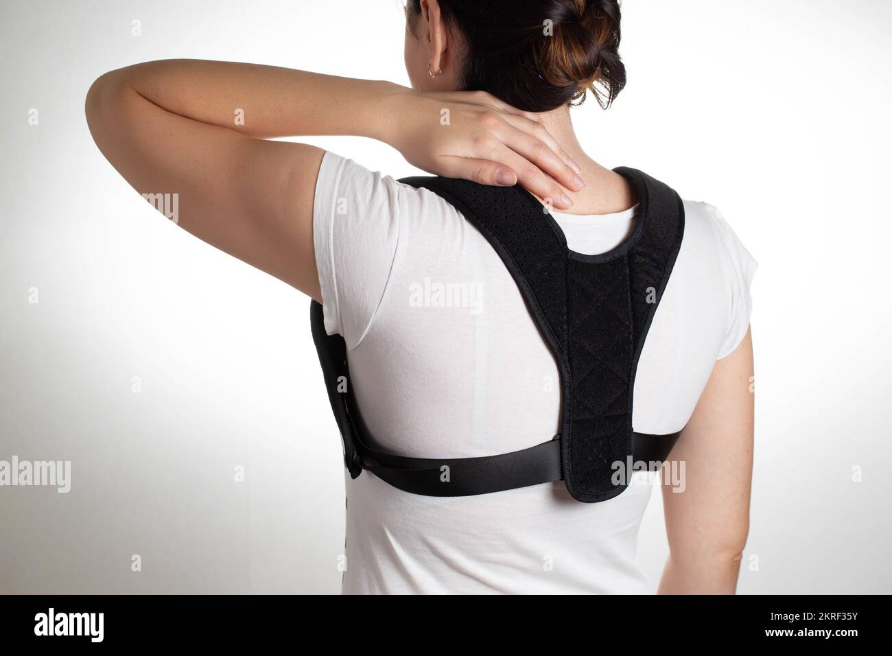 Woman in black posture corrector and fixation brace for the thoracic ...