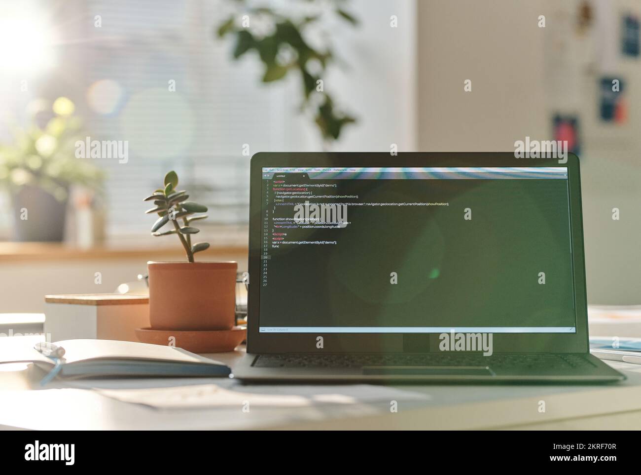 Close-up of laptop with codes on monitor standing on workplace of ...