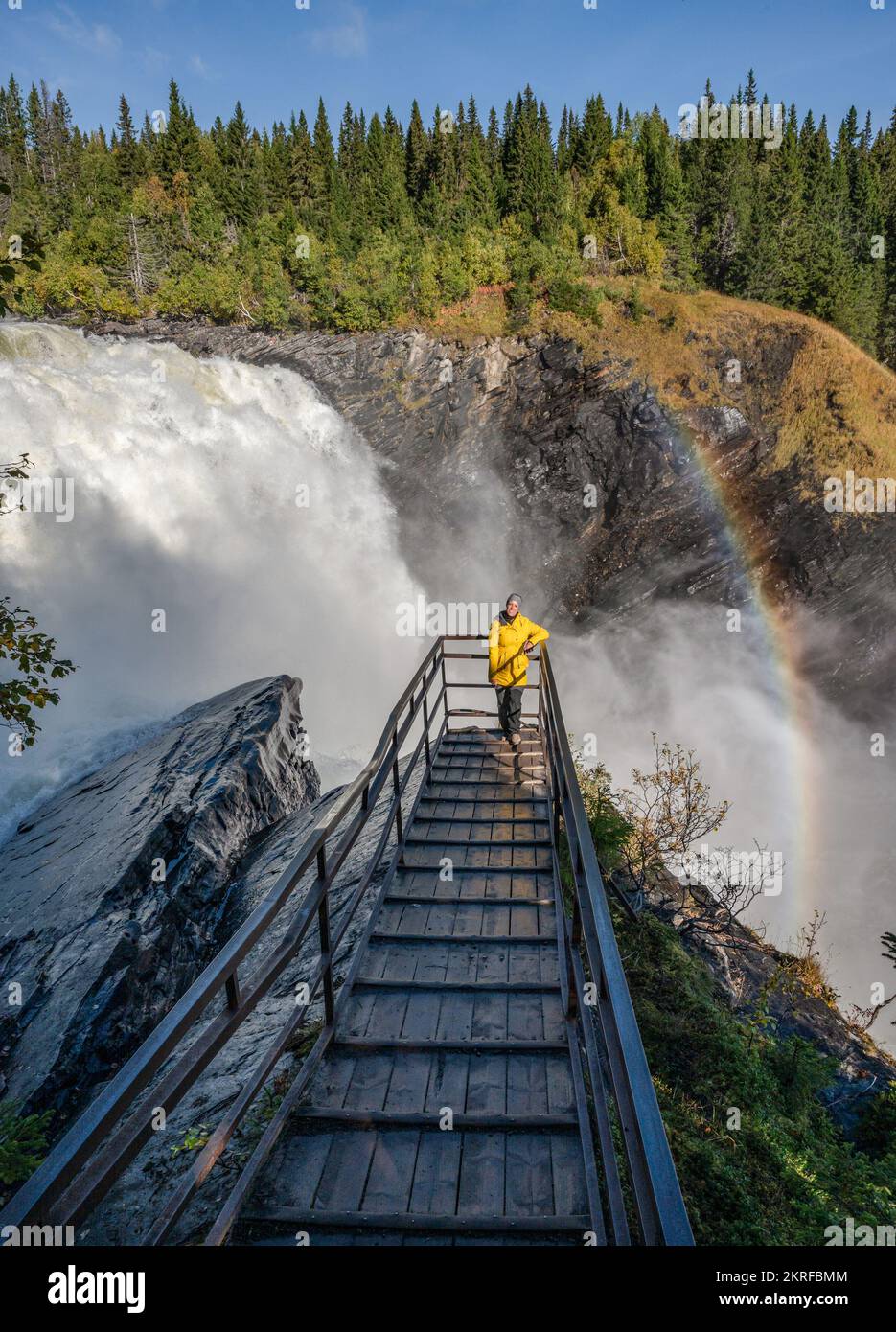 Girls standing on viewpoint bridge at Famous waterfall Tannforsen ...