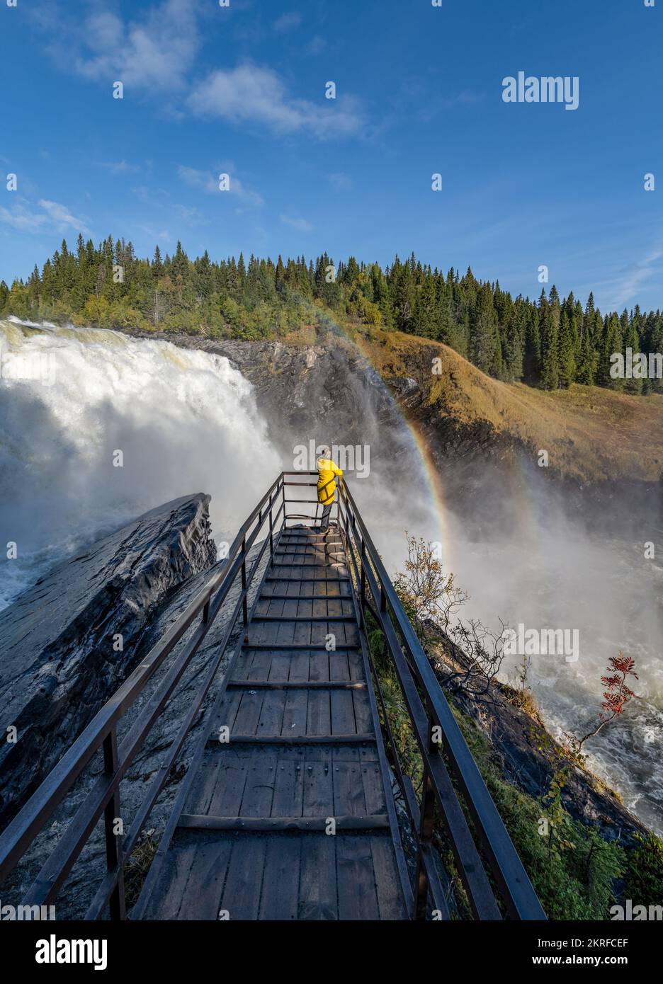 Girls standing on viewpoint bridge at Famous waterfall Tannforsen ...