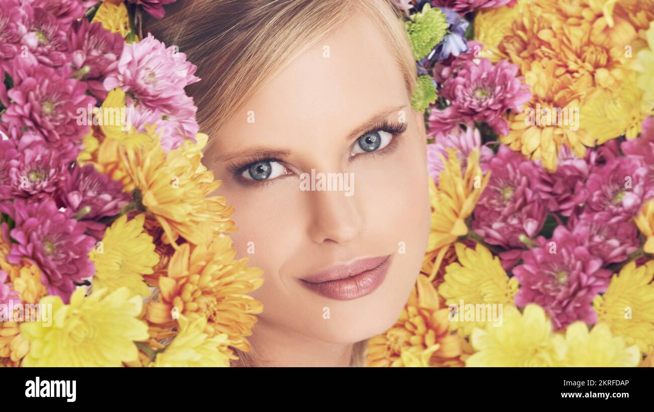 The flowers accentuate her natural beauty. Portrait of an attractive ...
