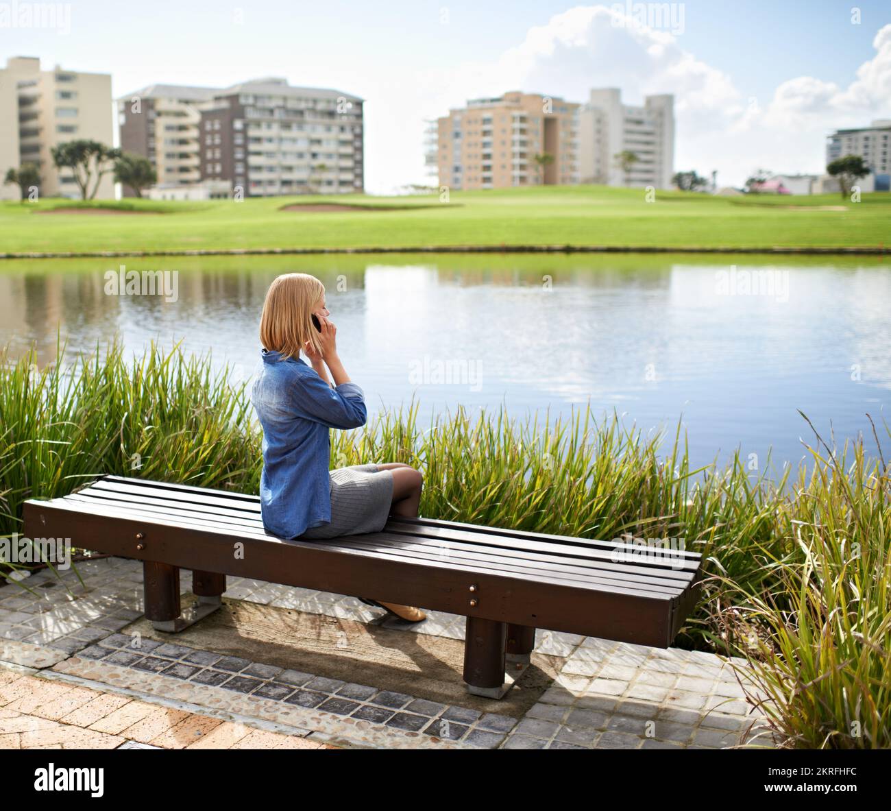 Its so peaceful out here. Rear view shot of a blonde woman talking on ...