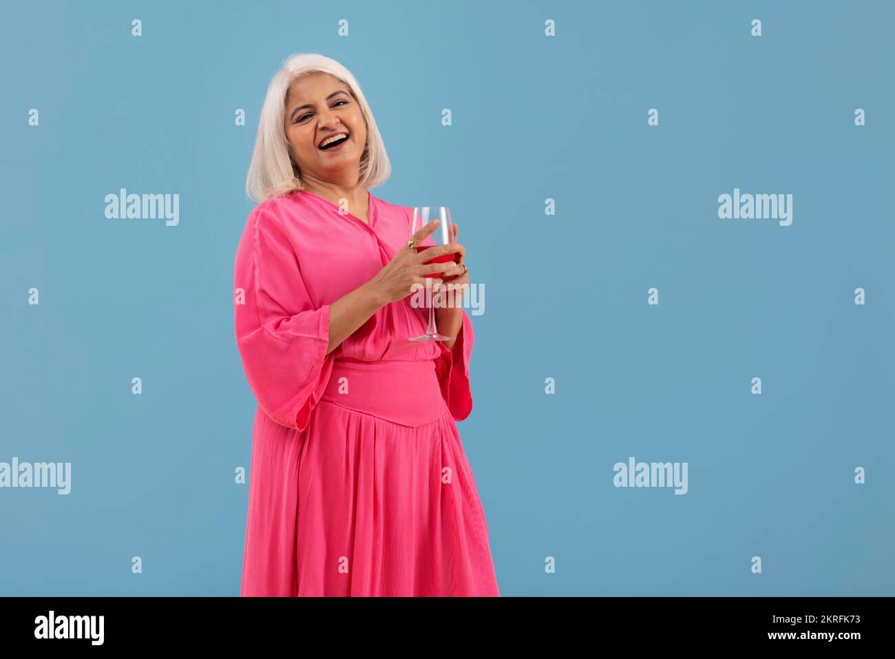 Portrait of a cheerful old lady standing with a glass of red wine Stock ...