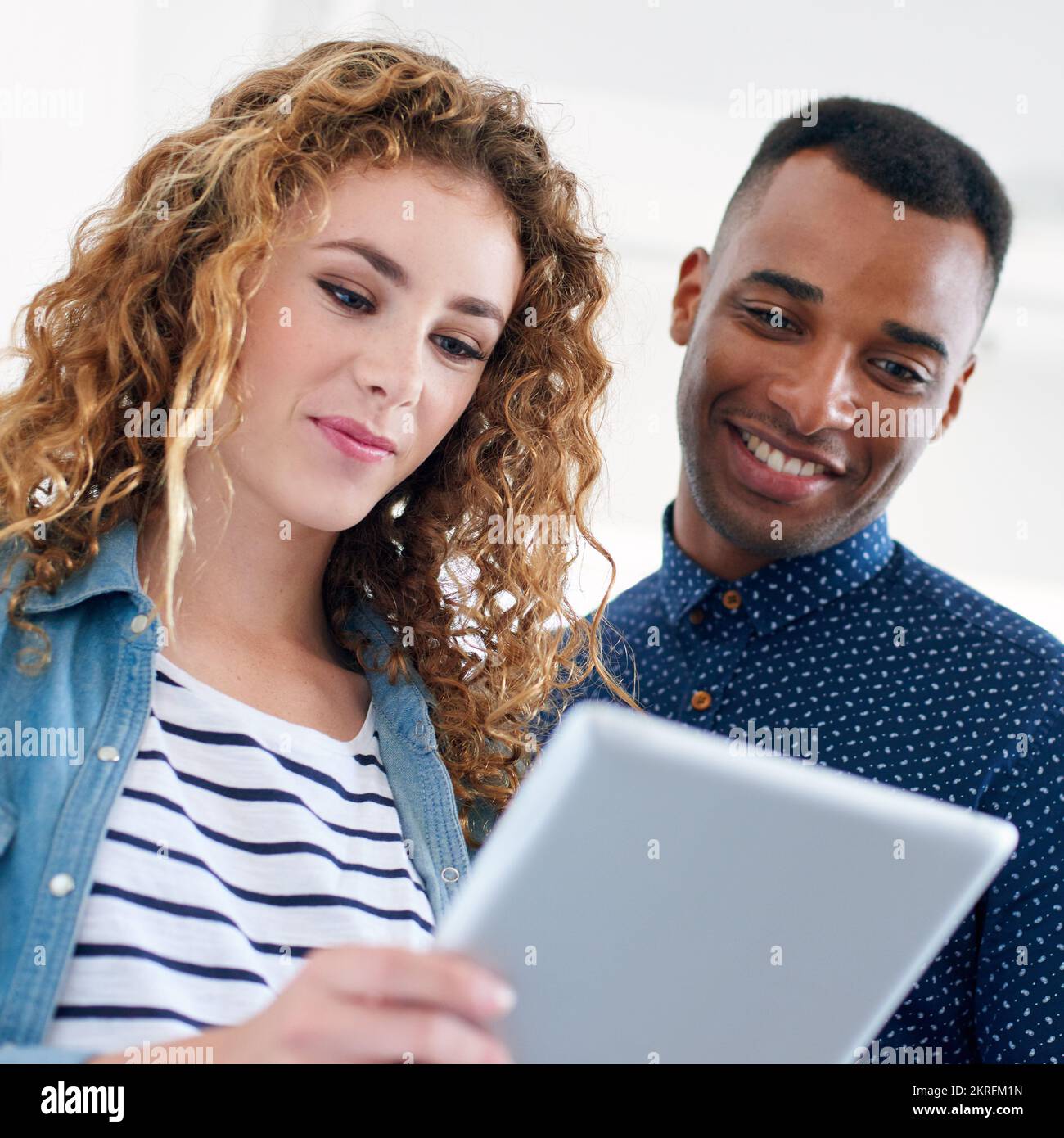 Well get any job done...together. two young colleagues using a digital ...