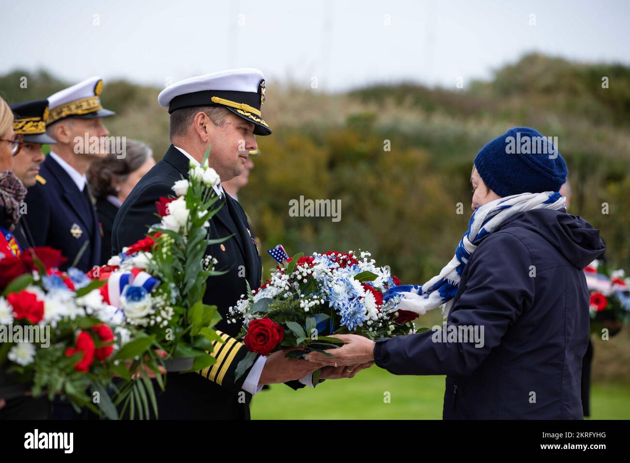 Capt. Gary M. Chase, commanding officer, USS Normandy receives a wreath ...