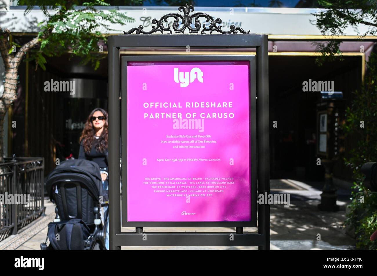 Signage is displayed promoting the Lyft rideshare app as an official ...