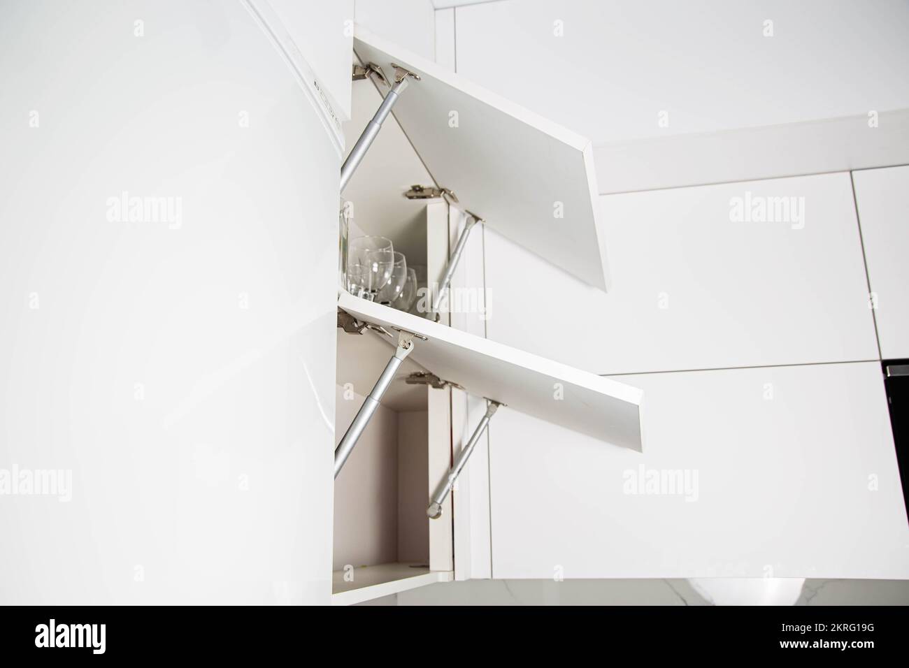 Modern white kitchen with new fittings with gas shock absorbers for ...